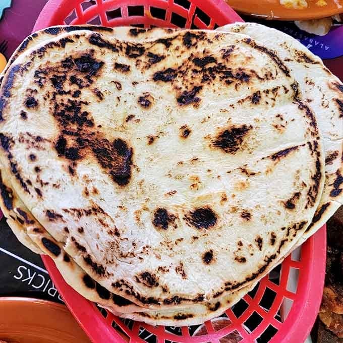 Fresh tortillas, charred to perfection and ready for their supporting role in the meal of your dreams. Simple, essential, and utterly irresistible.