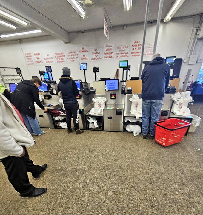 Modern efficiency meets thrift store values at these self-checkout stations, where shoppers finalize the day's treasure hunting expedition.