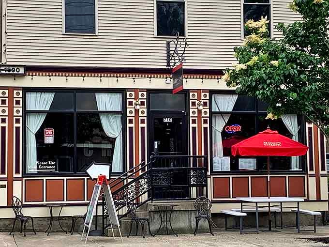 Cork N Crust's inviting storefront promises culinary delights without pretension. Red umbrellas beckon passersby to sit and stay awhile.
