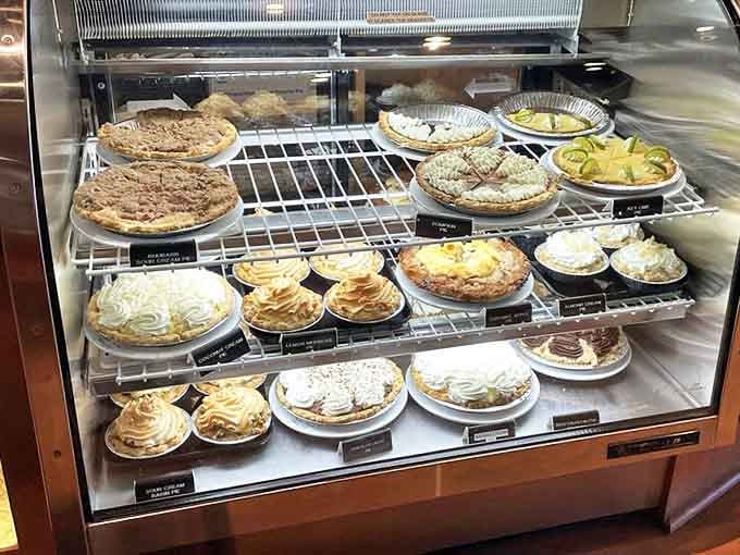 The dessert case presents a United Nations of pie varieties, where cream, fruit, and meringue coexist in sweet, peaceful harmony.