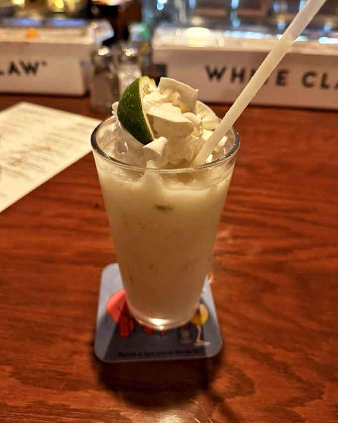 This isn't just a cocktail; it's a vacation in a glass, complete with a lime passport and whipped cream clouds.