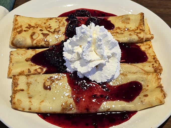 Crepes swimming in berry sauce with a cloud of whipped cream&mdash;dessert masquerading as breakfast, and nobody's complaining.