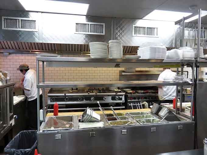 Behind the scenes in Mike's kitchen, where breakfast alchemy happens daily on well-seasoned grills that could tell stories of a million eggs.