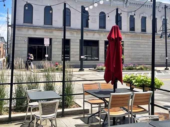 The outdoor patio offers urban al fresco dining where conversations flow as freely as the drinks, under umbrellas as red as Iowa tomatoes.