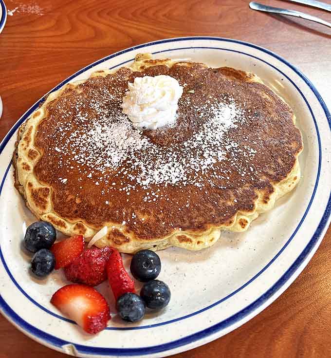 Pancakes that moonlight as pillows, dusted with powdered sugar and accessorized with fresh berries. Breakfast doesn't get more photogenic than this.