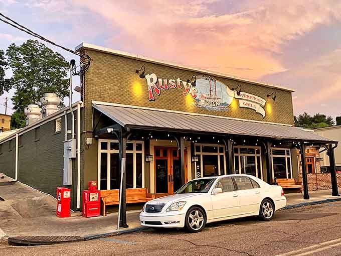 Rusty's Riverfront Grill glows at dusk, promising seafood and steaks with river views that would cost triple in coastal cities.