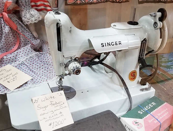 This pristine Singer sewing machine created wardrobes before fast fashion was invented. Its gleaming white finish and original manual promise precision from a simpler time.