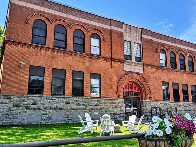 The Sherman Inn's brick facade and inviting white chairs promise relaxation and conversation. Small-town hospitality with architectural distinction.