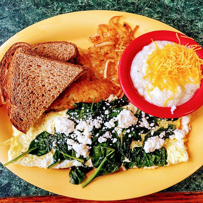 This spinach and feta omelet proves that healthy choices don't have to be punishment &ndash; especially when served with cheesy grits and crispy toast.