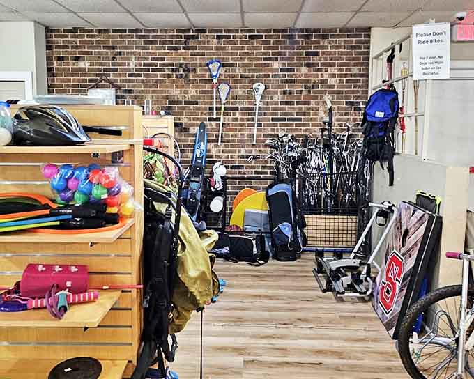 The sporting goods corner—where golf clubs lean like old friends sharing stories, and bicycles wait for their next adventure down a Carolina greenway.
