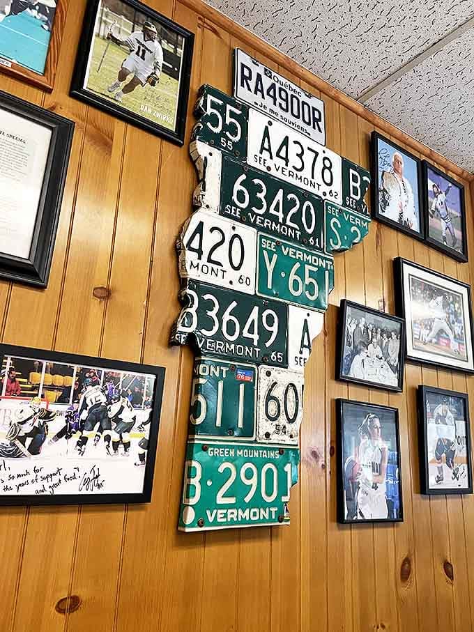 The wall doesn't just display license plates&mdash;it's a metal and enamel autobiography of Vermont itself, surrounded by local sports heroes.
