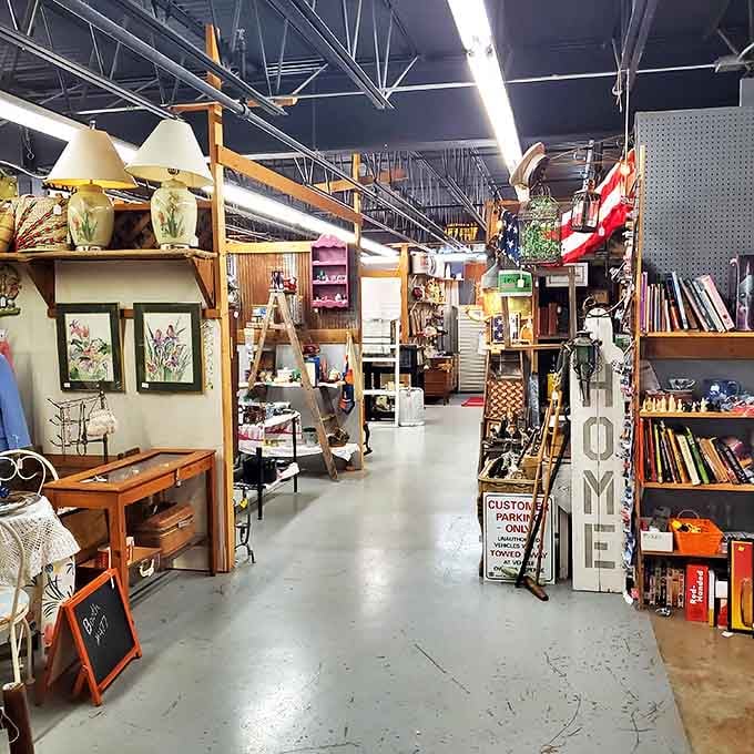 Antique row stretches into the distance with treasures stacked high on both sides. That "HOME" sign is practically begging to adorn someone's entryway.
