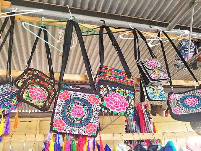 Embroidered bags bursting with color like portable gardens. Each stitch tells a story of craftsmanship that big box stores can only dream about.