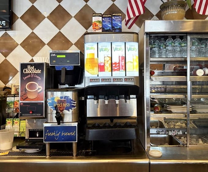 Beverage command center with its diamond-pattern backdrop&mdash;where juice, coffee, and iced tea flow like liquid gold. The American diner's version of a fancy cocktail bar.