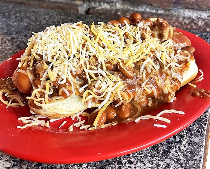 Chili dogs smothered in beans and cheese—where napkins aren't just suggested, they're mandatory equipment for this delicious mess.