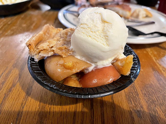Fruit cobbler crowned with vanilla ice cream melting into all the right places—a dessert so good it makes you consider skipping the main course next time.