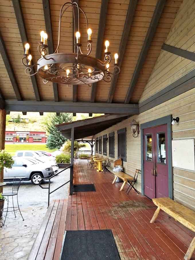 The welcoming porch with its wooden benches invites you to linger a moment longer, whether waiting for a table or digesting that second helping.