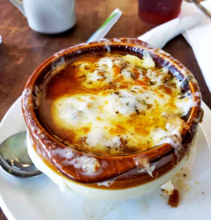 French onion soup with a cheese cap so perfect it deserves its own trophy&mdash;a bowl of savory comfort that warms you from the inside out.