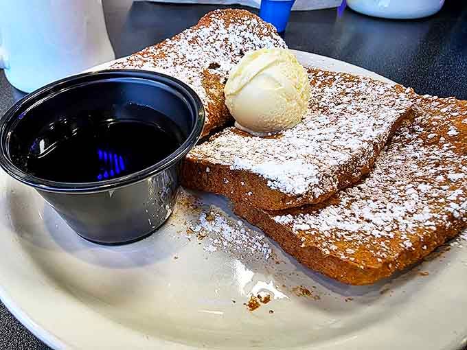 French toast that's dressed for dessert but shows up for breakfast, dusted with powdered sugar like a Vegas snowfall.