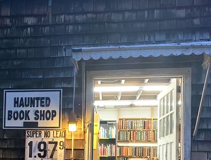 The "Haunted Book Shop" glows with inviting light, like a literary lighthouse beckoning readers through the darkness.