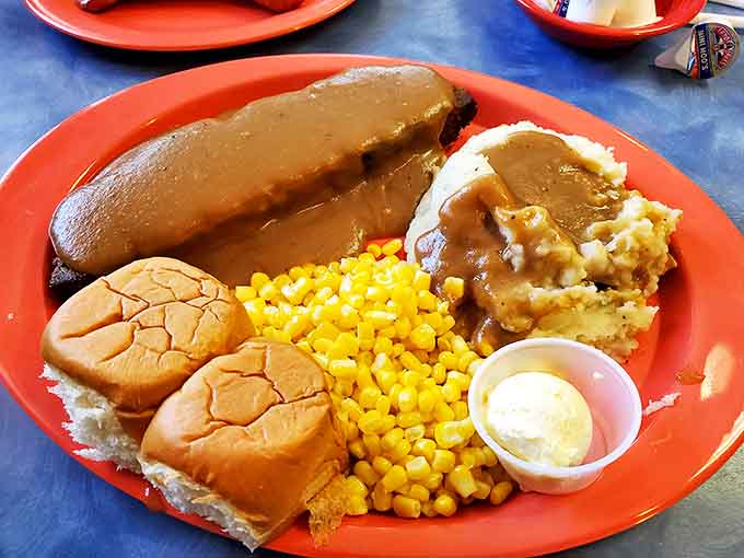Meatloaf dinner that would make your grandmother both proud and jealous. That gravy river flowing into mashed potato mountain is pure comfort geography.