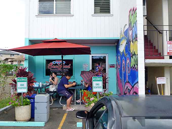 Lucky diners enjoying their poke treasures at Ono's outdoor tables, their expressions saying what words cannot: "This is the real deal."