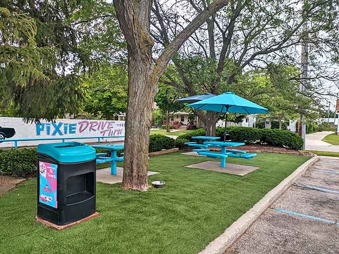 Outdoor seating with matching teal picnic tables creates a perfect summer spot for enjoying those burgers while soaking up Michigan sunshine.