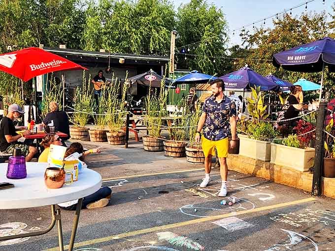 The outdoor patio transforms summer evenings into magical gatherings. String lights twinkle overhead while live music and games create the perfect backdrop for making memories.