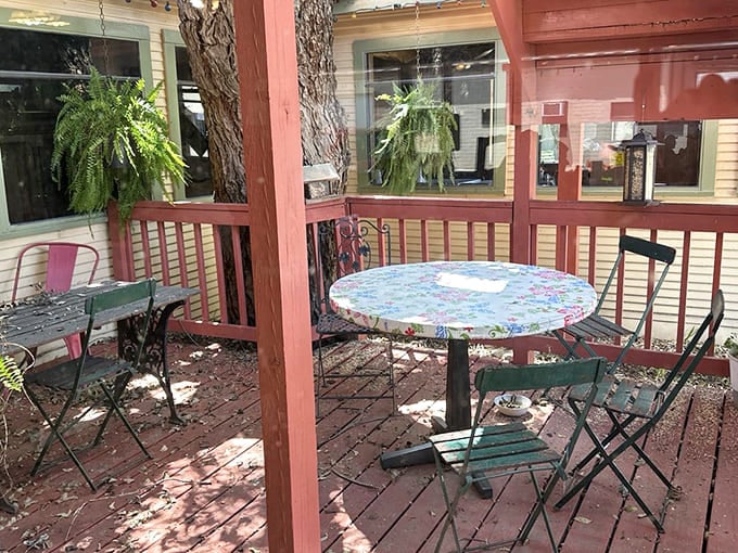 Outdoor seating with floral tablecloths and hanging ferns creates a secret garden vibe&mdash;the perfect spot to savor pie and coffee on a mild Texas afternoon.