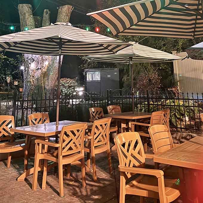 Outdoor dining beneath striped umbrellas where summer evenings stretch luxuriously like cats in sunshine. The perfect spot for people-watching with a pint.