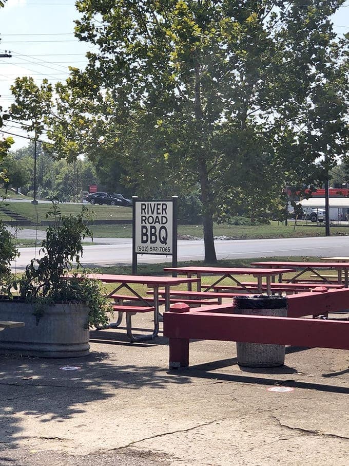 Outdoor picnic tables bathed in dappled sunlight offer the authentic BBQ experience &ndash; casual, communal, and completely satisfying.