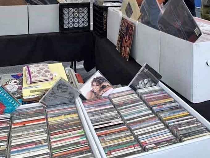 Vinyl treasures await their next spin, each album cover a portal to memories of first dances, road trips, and teenage bedrooms.