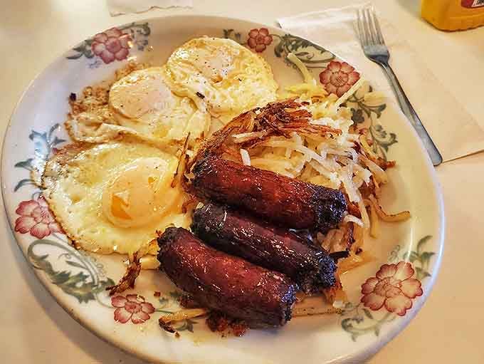 The breakfast trinity: perfectly fried eggs, crispy hash browns, and sausage links that snap when bitten. Simple pleasures that fancy brunches can't improve upon.
