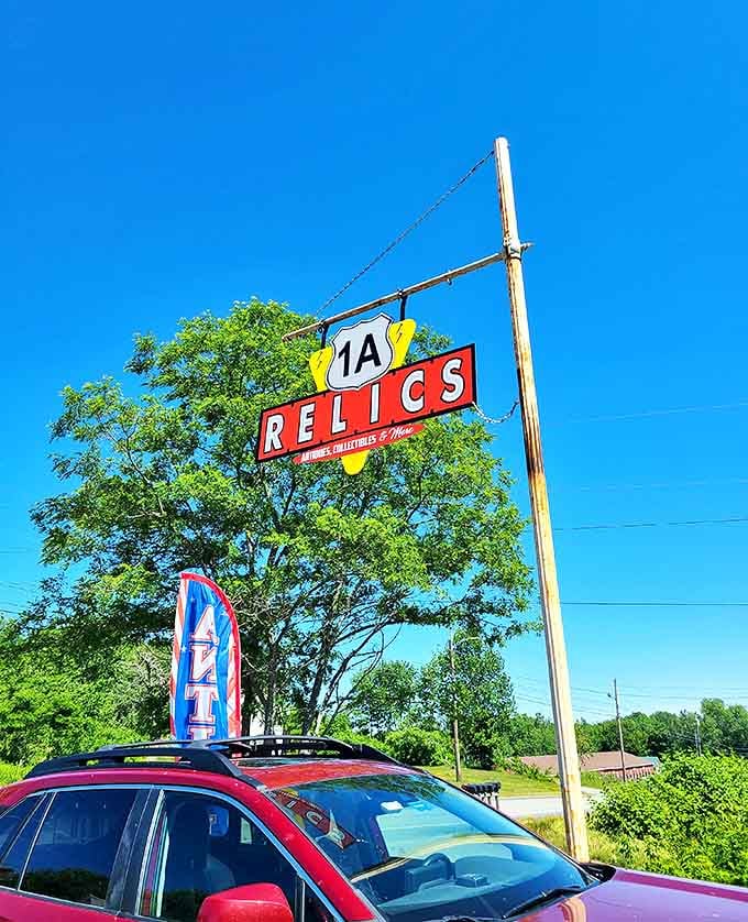 The 1A Relics sign stands tall against Maine's blue sky, a beacon for collectors. Like the North Star for those navigating the seas of vintage finds.