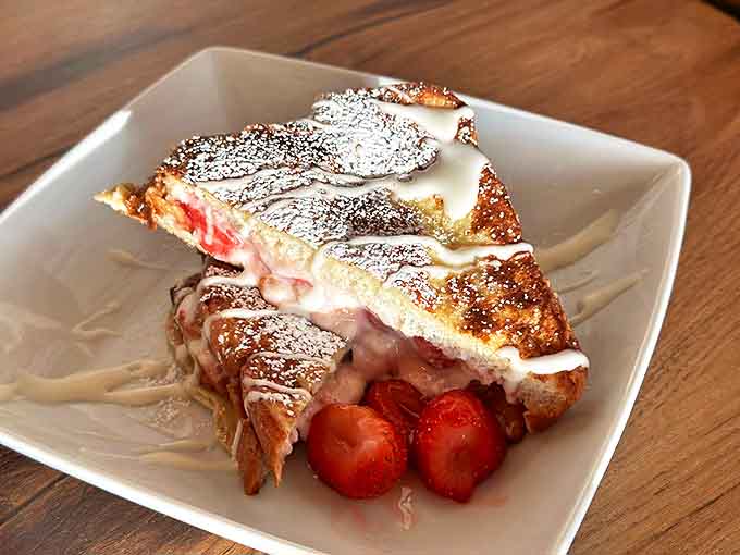 Stuffed French toast that makes you question every other breakfast you've ever had. The powdered sugar snowfall is pure Montana poetry.