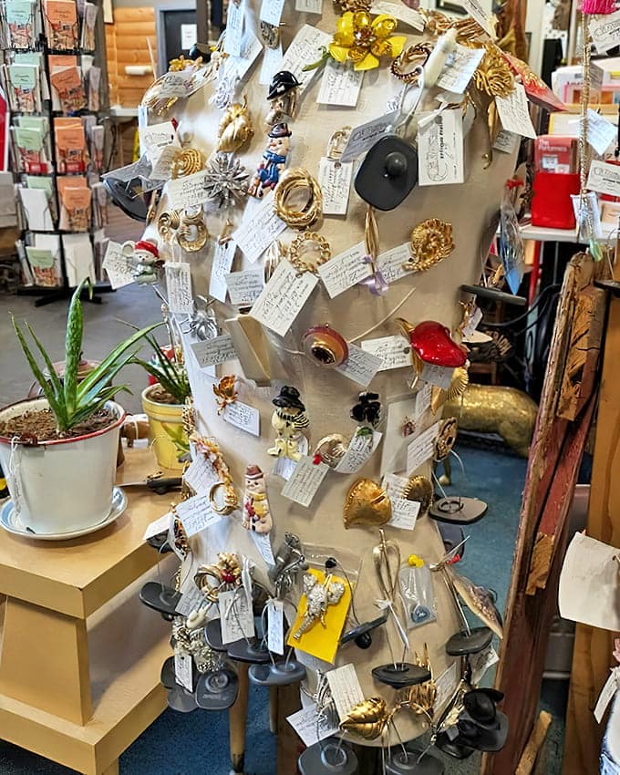 A mannequin transformed into a jewelry display tree. Vintage brooches and pins create a wearable timeline of American fashion statements.