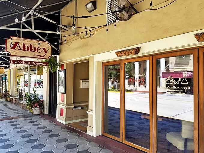 The Abbey Bar's warm exterior beckons passersby to step in from the Florida sunshine for craft beverages and local camaraderie.