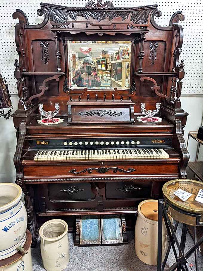 A magnificent pump organ that once provided the soundtrack to family gatherings and community events, its ornate woodwork a masterpiece of craftsmanship.