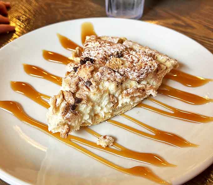 Cannoli pie with caramel drizzle&mdash;proof that Sally's doesn't just master the main course. The sweet finale to a perfect pizza symphony.