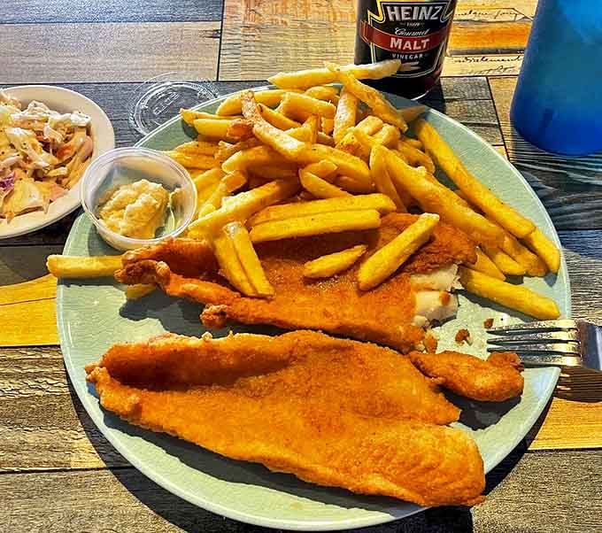 Fish and chips so golden they deserve their own Fort Knox. Crispy on the outside, flaky on the inside&mdash;the British got something right.