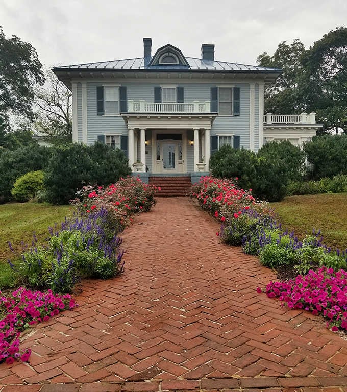 Fountain Hall's brick pathway and blooming gardens create the kind of entrance that makes you wonder if you've accidentally wandered onto a movie set.