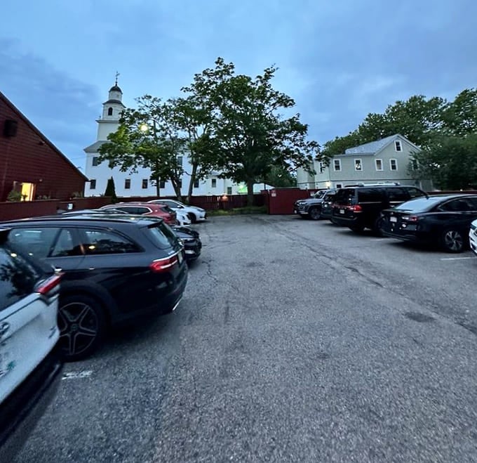 From horse-drawn carriages to SUVs. The tavern's parking lot shows how transportation has changed while the destination remains eternally appealing.