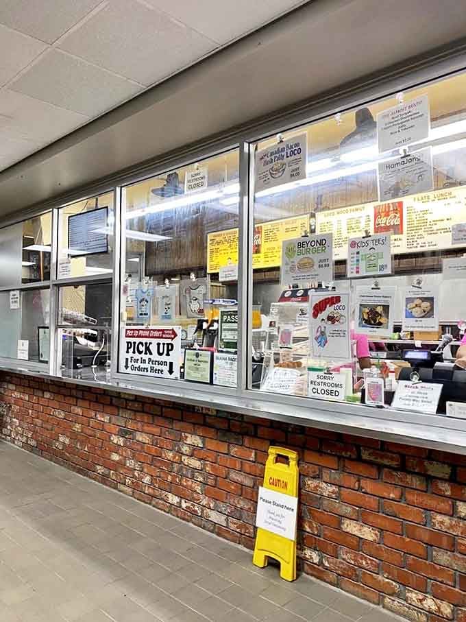 The ordering window—where dreams come true and diets go to die, all with a smile and the efficiency of a well-oiled machine.