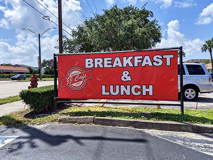 The roadside banner announces JJ Cafe's mission with no-nonsense clarity: Breakfast & Lunch, the two meal pillars that Florida days are built upon.