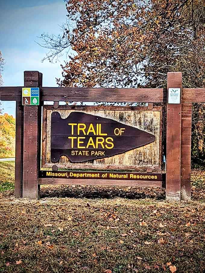 The entrance sign tells two stories. A somber historical reminder and an invitation to experience natural beauty&mdash;both equally important parts of this park's identity.
