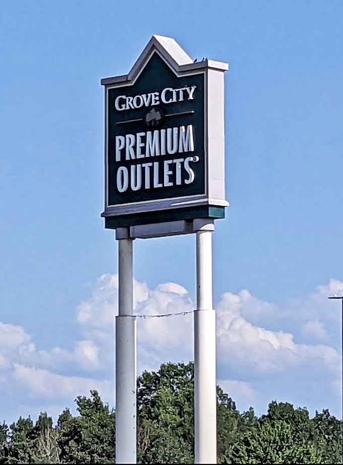 The iconic sign beckons like a retail lighthouse, guiding shoppers to the promised land of discounts and designer finds.