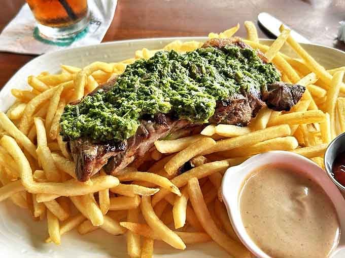 Sometimes a perfectly cooked steak needs nothing more than golden fries and a vibrant sauce to create a plate of pure satisfaction.