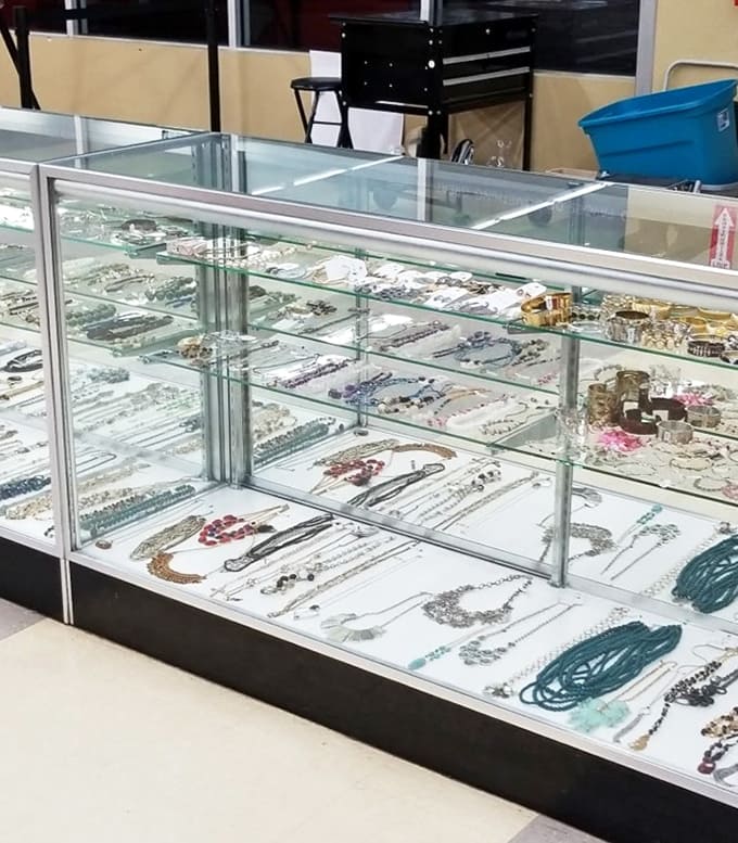 Behind glass, costume jewelry sparkles with potential. These forgotten treasures are just waiting for their moment to shine again.