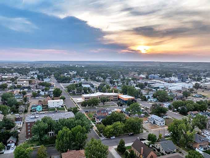 Sunset paints Miles City in golden hues, revealing its perfect scale. Not too big, not too small—this aerial view showcases a community designed for comfortable living.