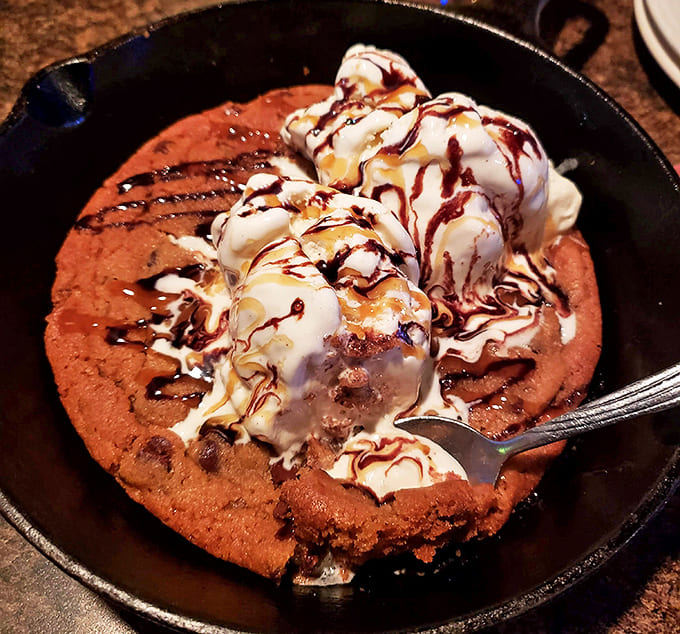 The skillet cookie &ndash; where childhood nostalgia meets adult indulgence. That melting ice cream creates a hot-cold tension that makes every bite an event.